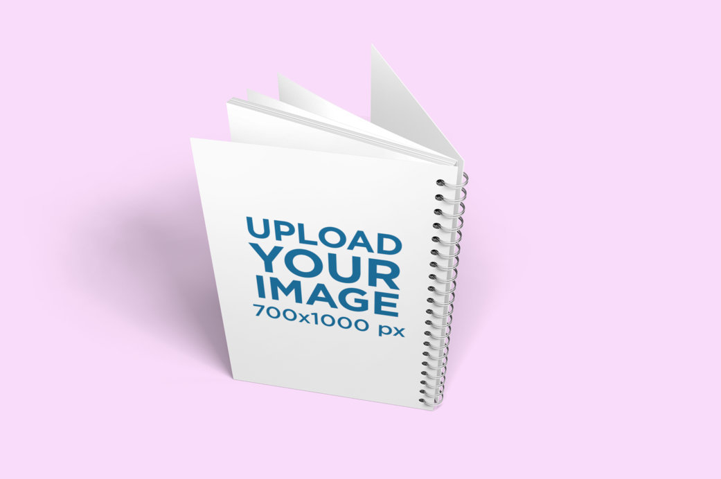 Placeit - Mockup of a Spiral Notebook Standing in a Plain Color Setting