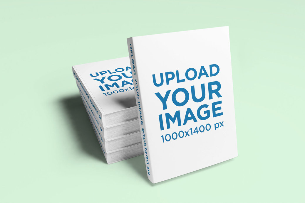 Placeit - Mockup of a Hard Cover Book Leaning on a Pile of Books