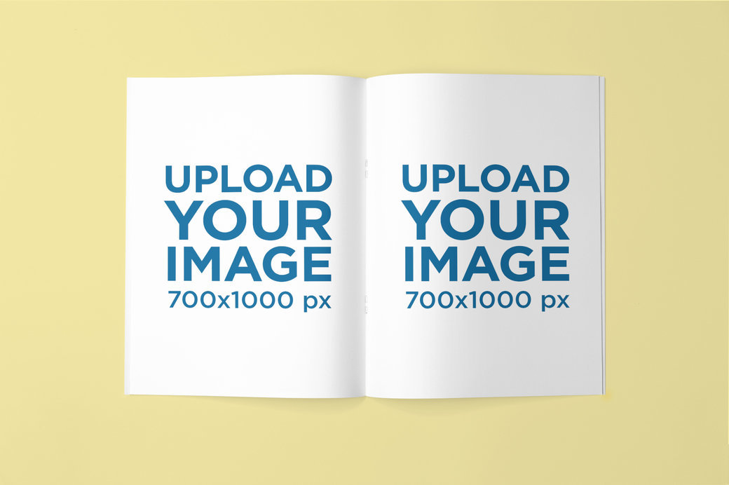 Placeit - Mockup Featuring an Open Magazine Lying Against a Plain Backdrop
