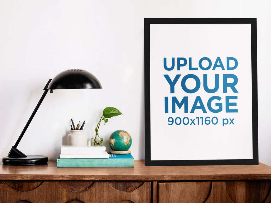 Placeit - Mockup Template of a Poster Standing on a Wooden Desk