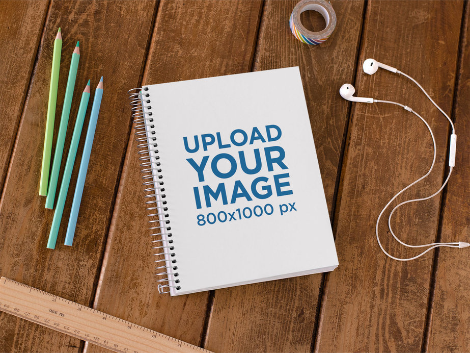 Placeit - Mockup of a Spiral Notebook Lying on a Wooden Table Next to ...