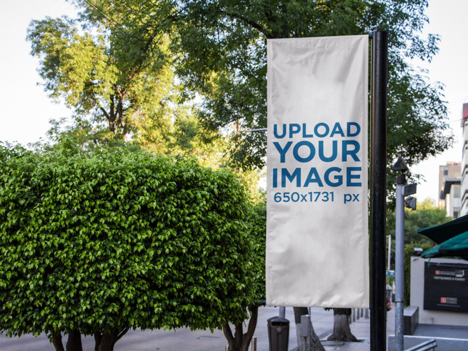 Placeit - Mockup of a Vertical Banner at an Outdoors Environment