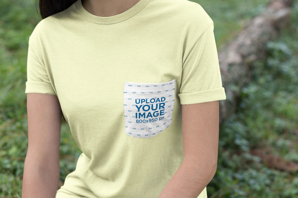 Placeit - Pocket Tee Mockup of a Woman by a Green Area