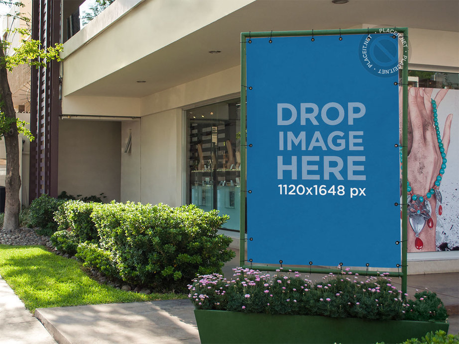 Placeit - Mockup of a Vertical Banner Outside a Store