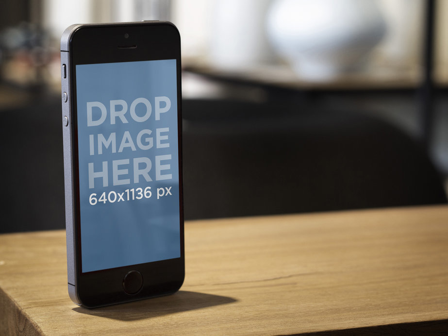 Placeit - Mockup of an iPhone Standing on a Clear Wooden Surface