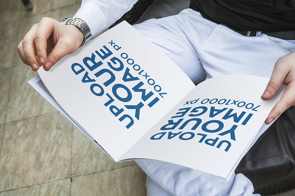 Placeit - A4 Magazine Mockup Featuring a Man Reading