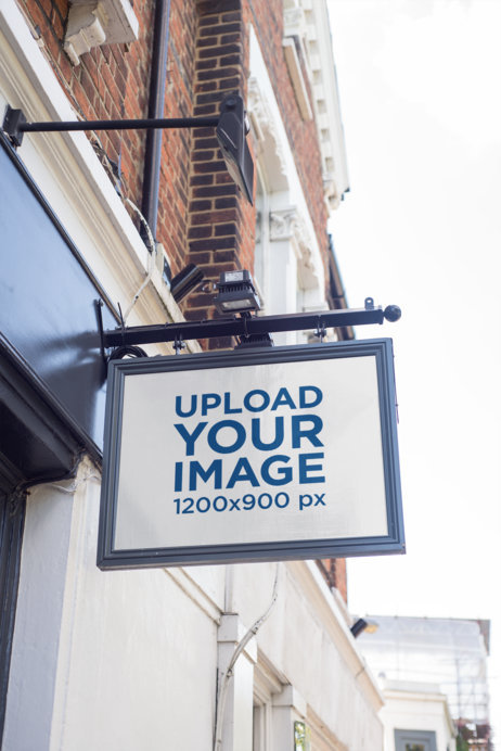 Placeit - Mockup of a Shop Sign at a Clear Street