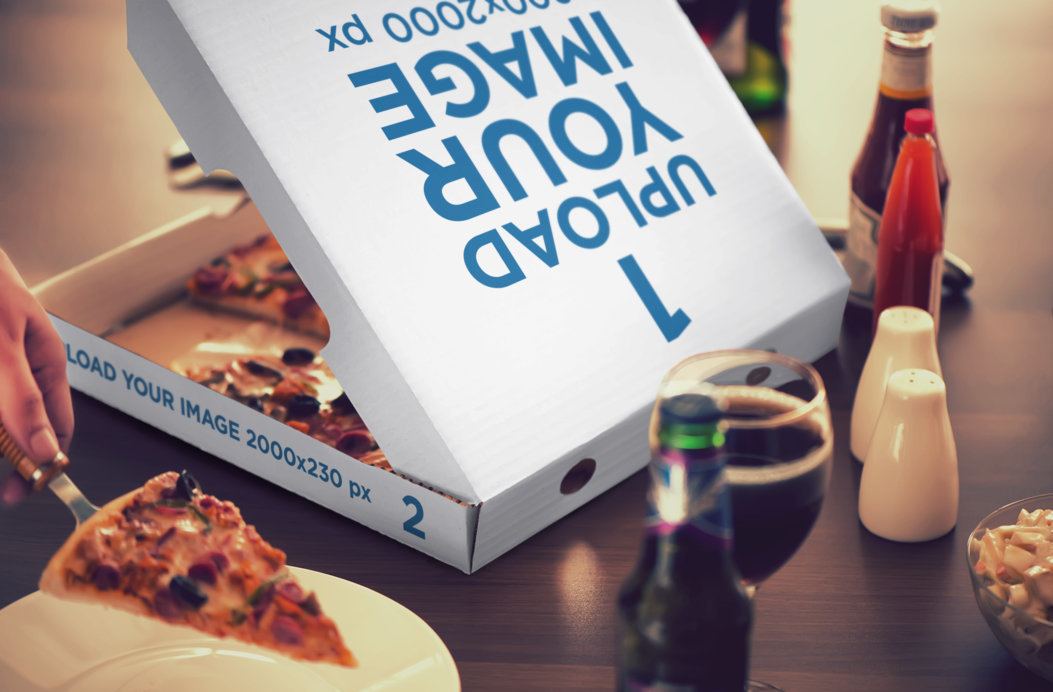Placeit - Mockup of a Pizza Box on a Table Surrounded by Glasses and Sauces