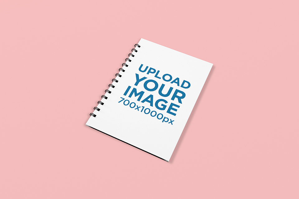 Placeit - Mockup of an Angled Spiral Notebook Against a Plain Background