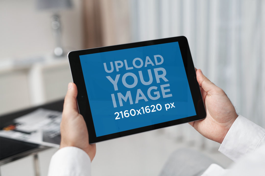 Placeit - Mockup Featuring a Man Holding an iPad