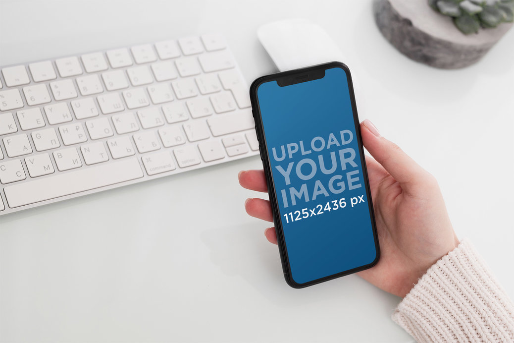 Placeit - Mockup Featuring a Woman's Hand Holding an iPhone 11 Pro over ...