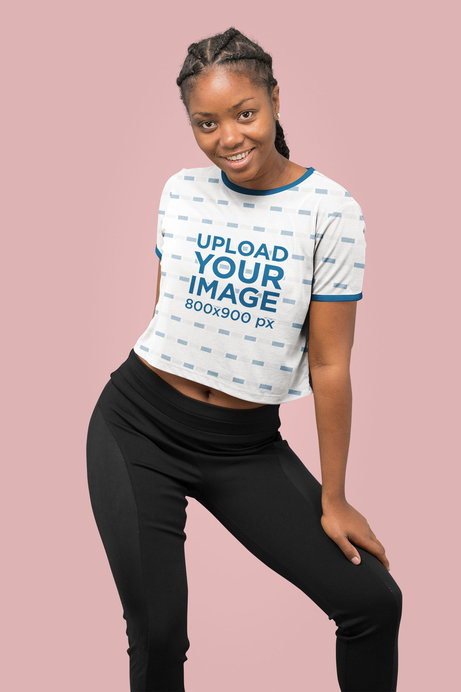 Placeit - Mockup of a Woman with a Sublimated Ringer Crop Top at a Studio