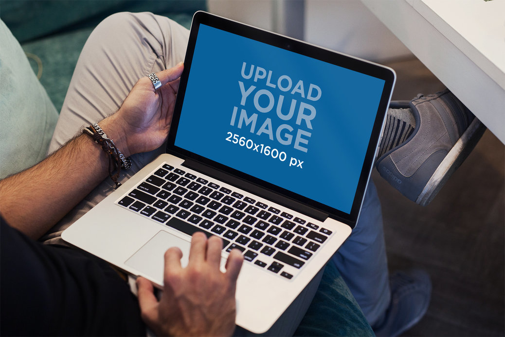 Placeit - MacBook Pro Mockup Featuring a Modern Man Using His Computer
