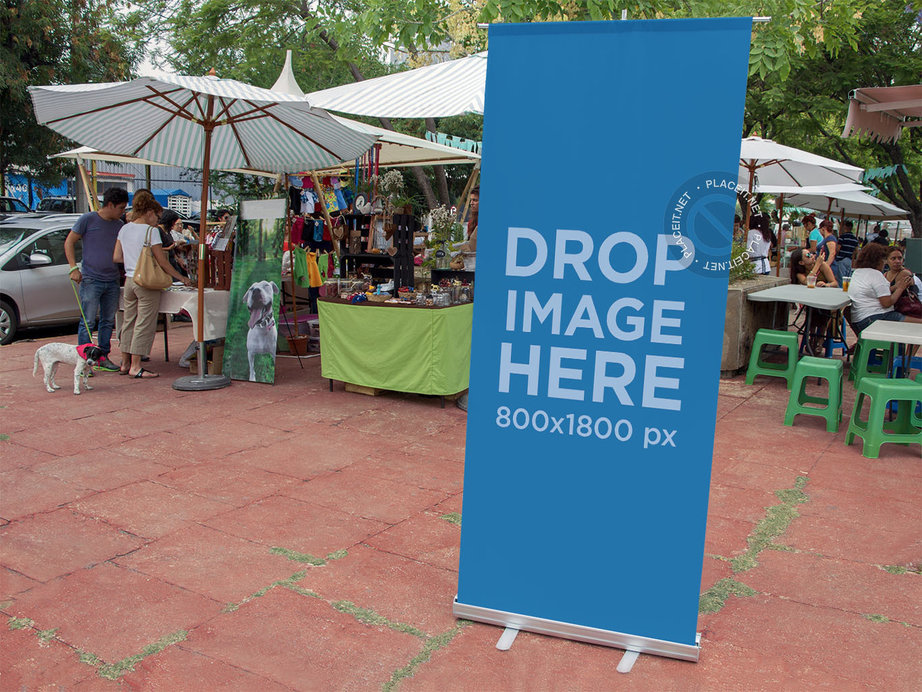 Placeit - Roll-Up Banner Mockup at an Outdoor Bazaar