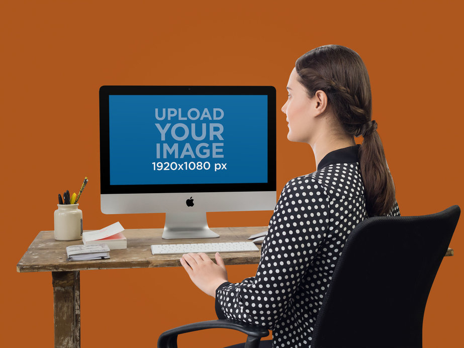 Placeit - iMac Mockup of a Woman Typing on Her Desktop Computer