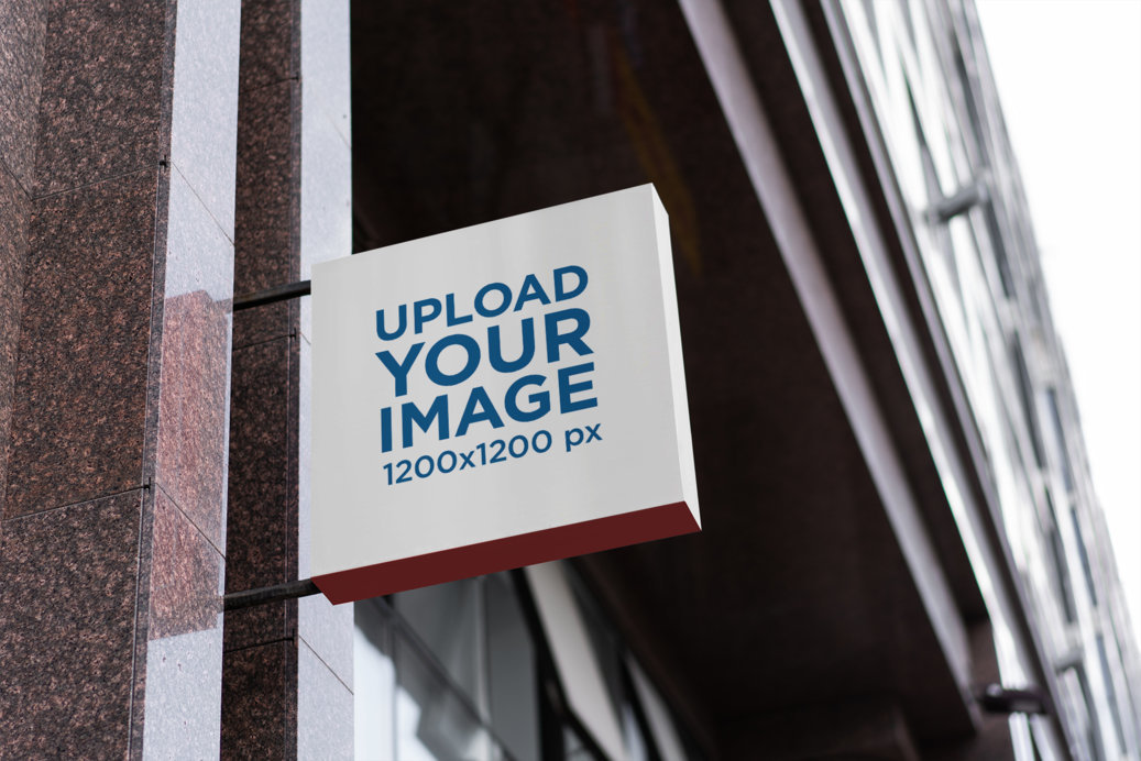 Placeit - Mockup of a Sign Attached to a Tall Building