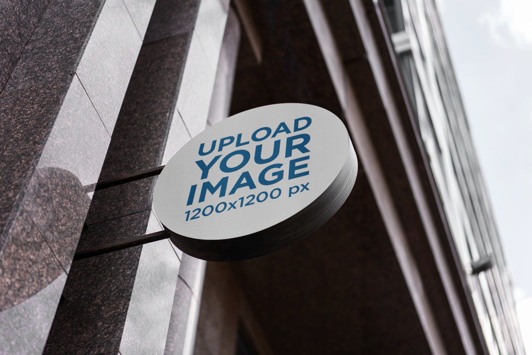 Placeit - Circular Sign Mockup Featuring a Modern Building