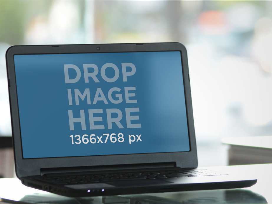 Placeit - Mockup of a Laptop on a Glass Table
