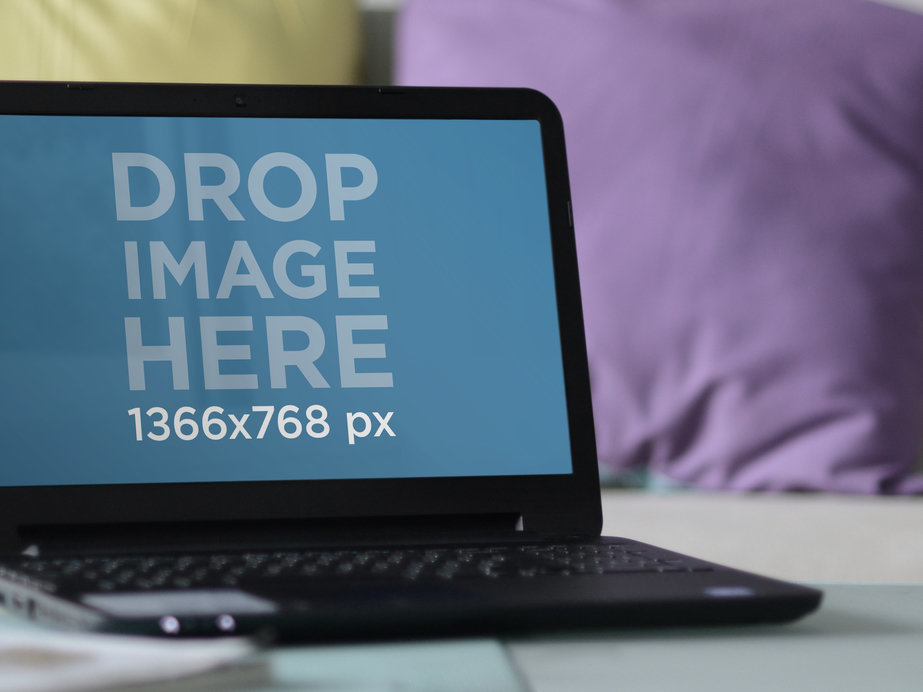 Placeit - Mockup of a Laptop in a Living Room