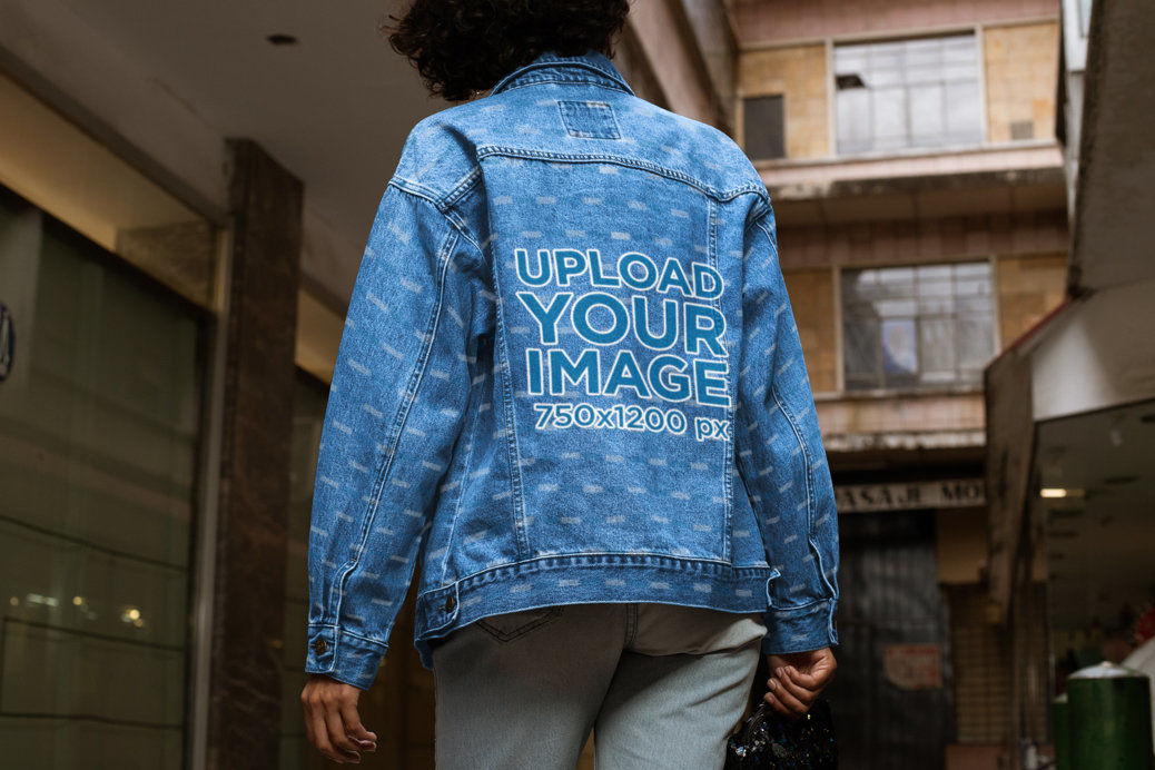 Placeit - Back-View Denim Jacket Mockup of a Woman in an Urban Scenario