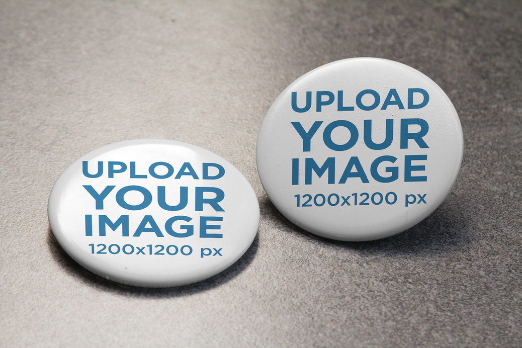 Placeit - Mockup of Two Pin Buttons on a Plain Surface