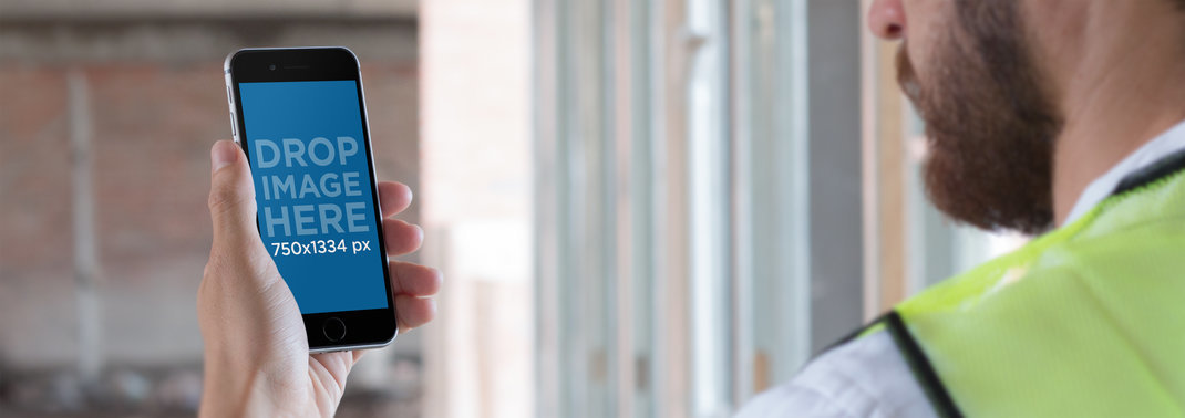Placeit - iPhone 6 Mockup of a Construction Worker Checking his Phone