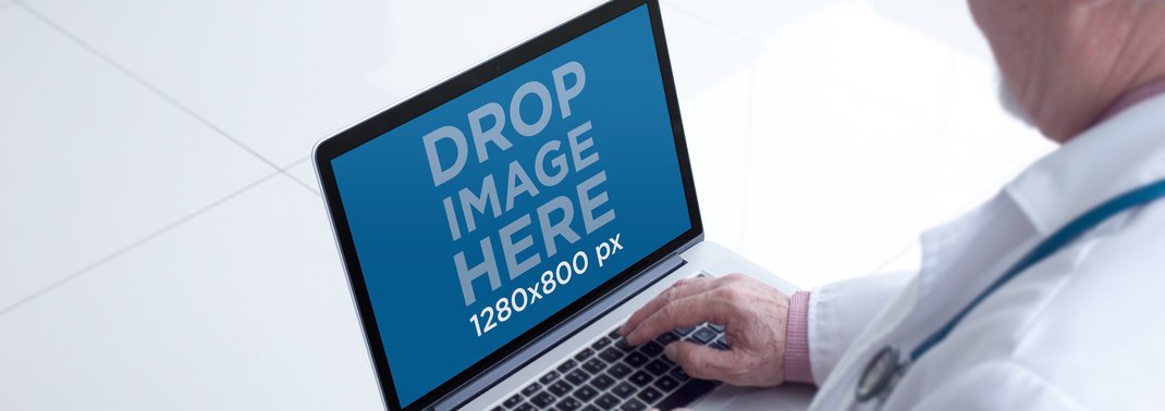 Placeit - Senior Doctor Working on his MacBook Pro Mockup