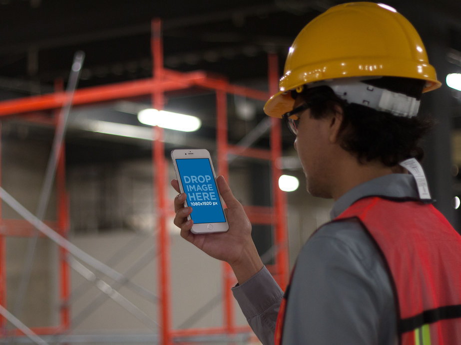 Placeit - Mockup of an iPhone 6 Plus Held by a Civil Engineer