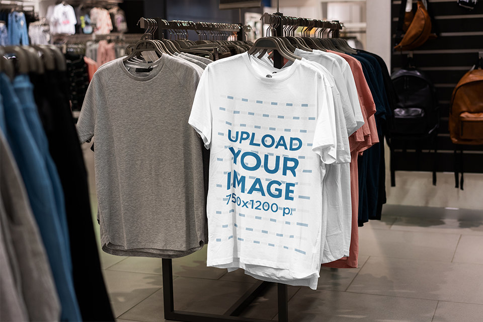 Placeit - Mockup of a T-Shirt Hanging From a Rack at a Clothing Store