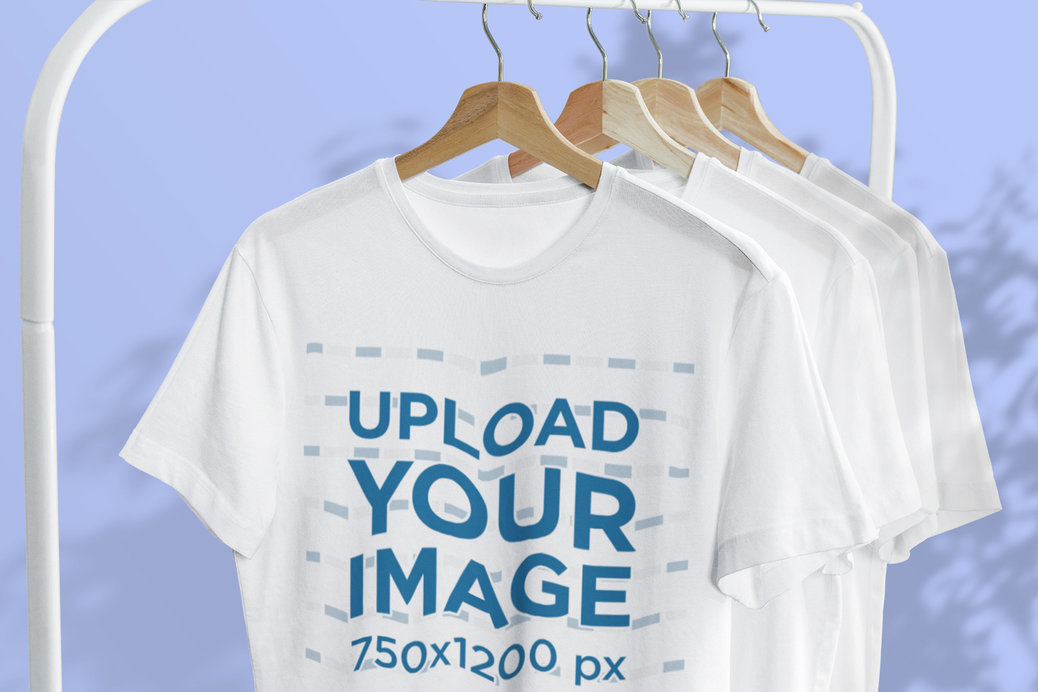 Placeit - Mockup Featuring Some T-Shirts Hanging on a Rack with a ...