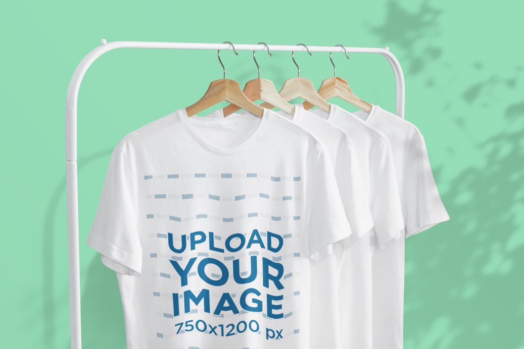 Placeit - Mockup of Four T-Shirts Hanging From a Metal Clothing Rack