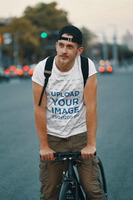 Placeit - T-Shirt Mockup Featuring a Young Man Riding His Bike