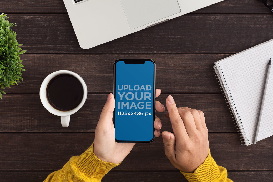 Placeit - Mockup of a Woman Using an iPhone 11 at Work