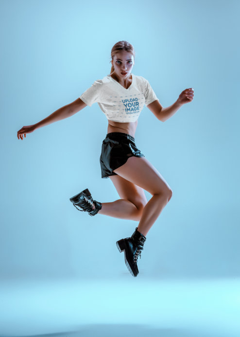 Placeit - Crop Top Mockup of a Woman Jumping in a Studio
