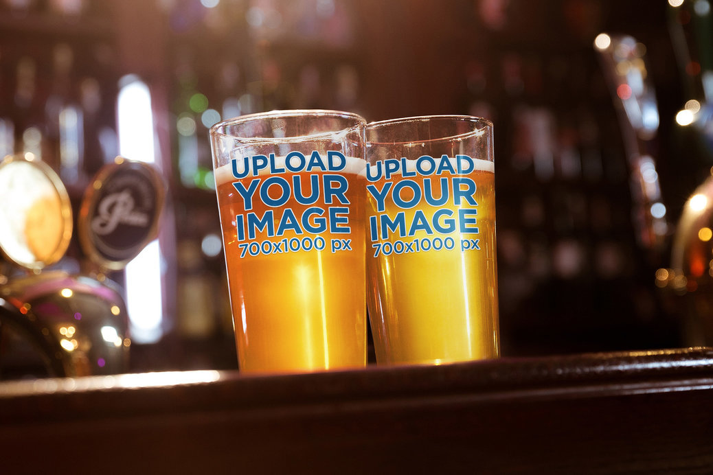 Placeit - Mockup of Two Beer Glasses on a Bar Counter