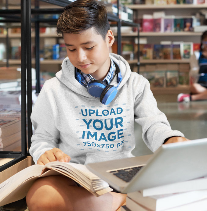 Placeit - Heather Hoodie Mockup of a Teenager Studying at the Library