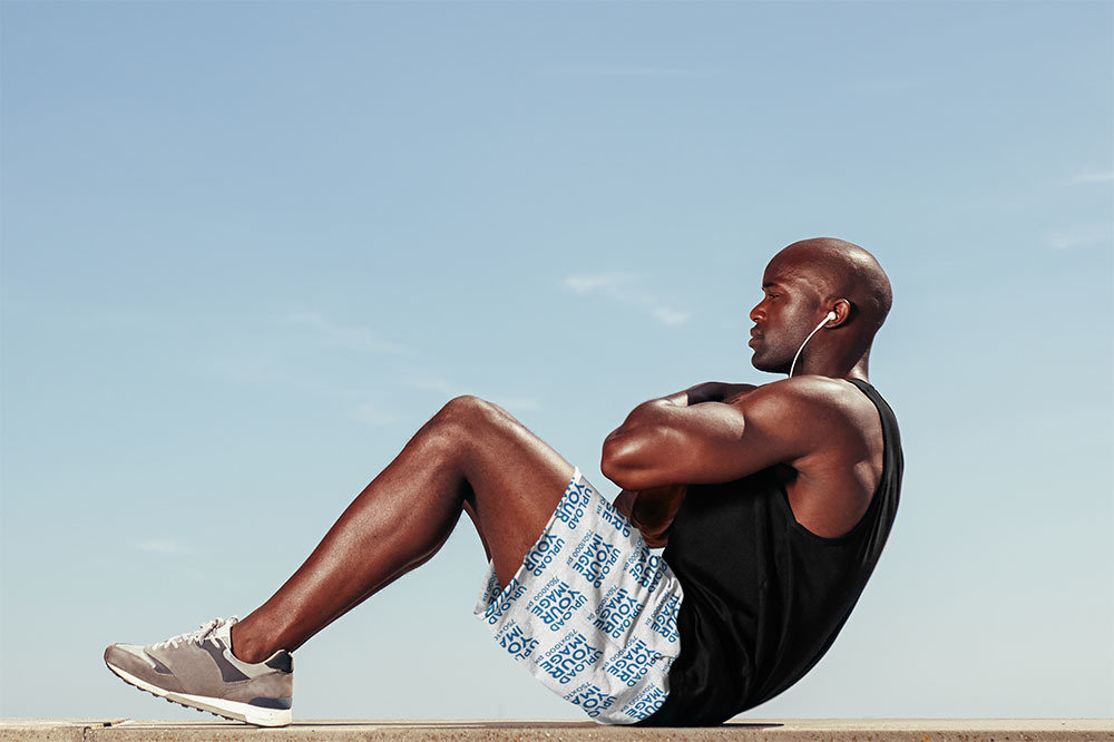 Placeit - Sportswear Shorts Mockup of a Man Doing Crunches