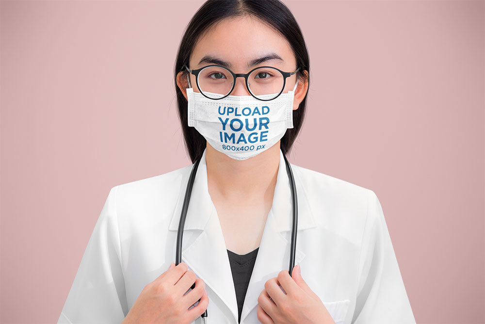 Placeit - Face Mask Mockup Featuring a Female Doctor at a Studio
