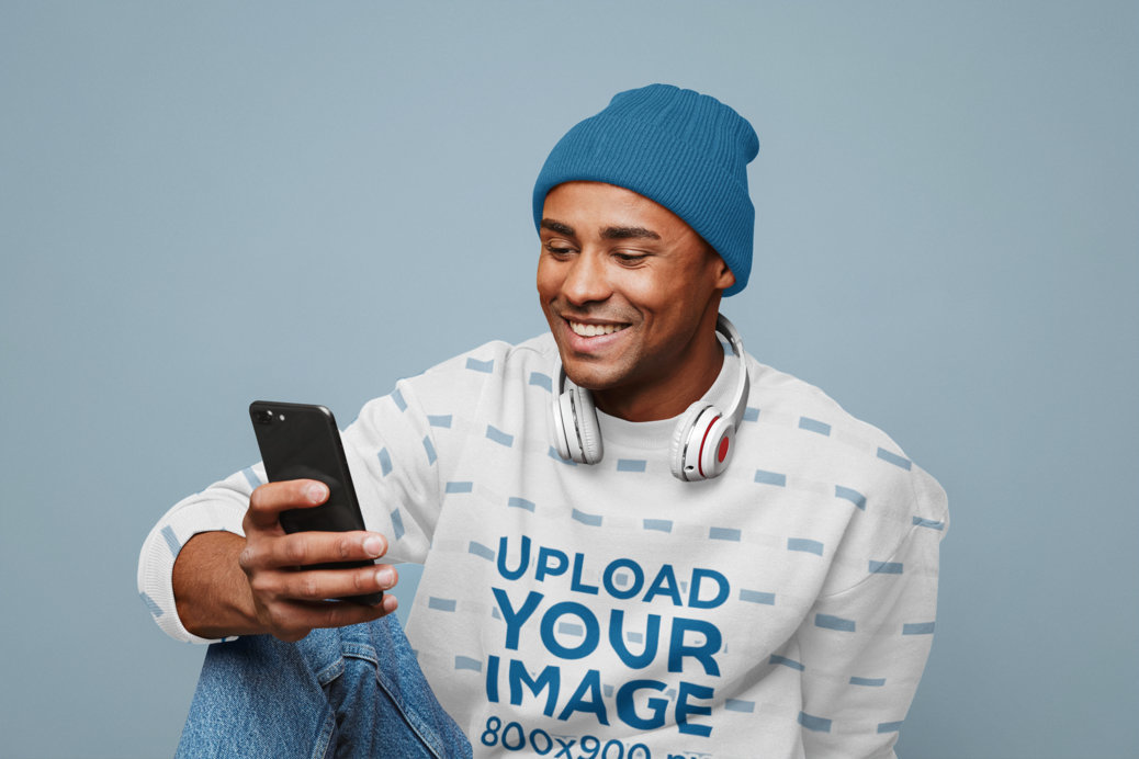 Placeit - Sublimated Sweatshirt Mockup of a Happy Man Checking His Phone