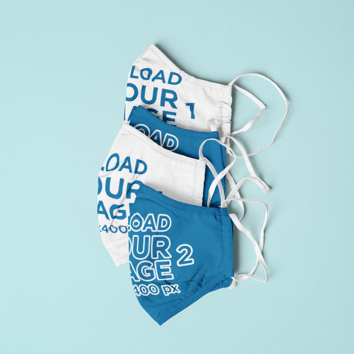 Placeit - Mockup Featuring Four Face Masks Placed on a Colored Surface