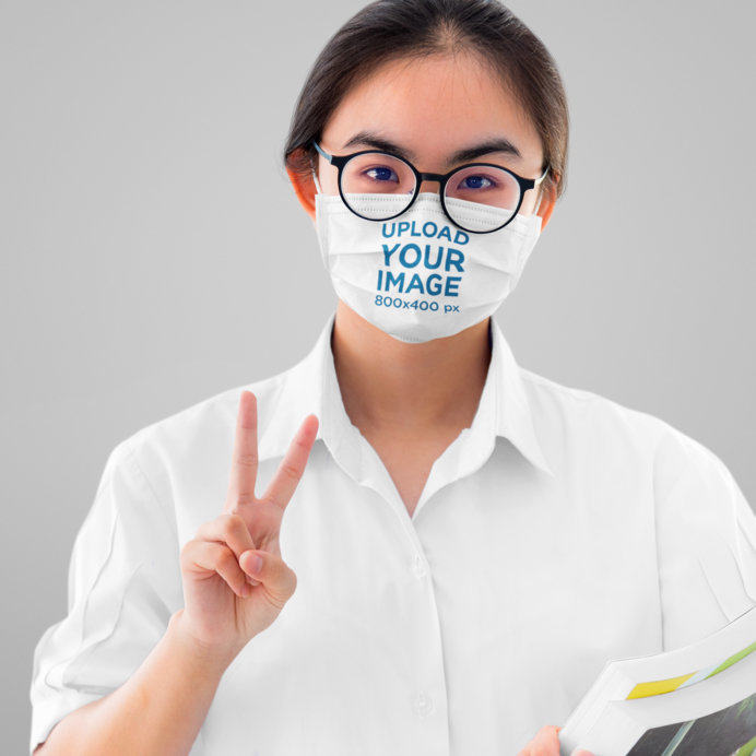 Placeit - Face Mask Mockup of a Woman Making a Peace Sign