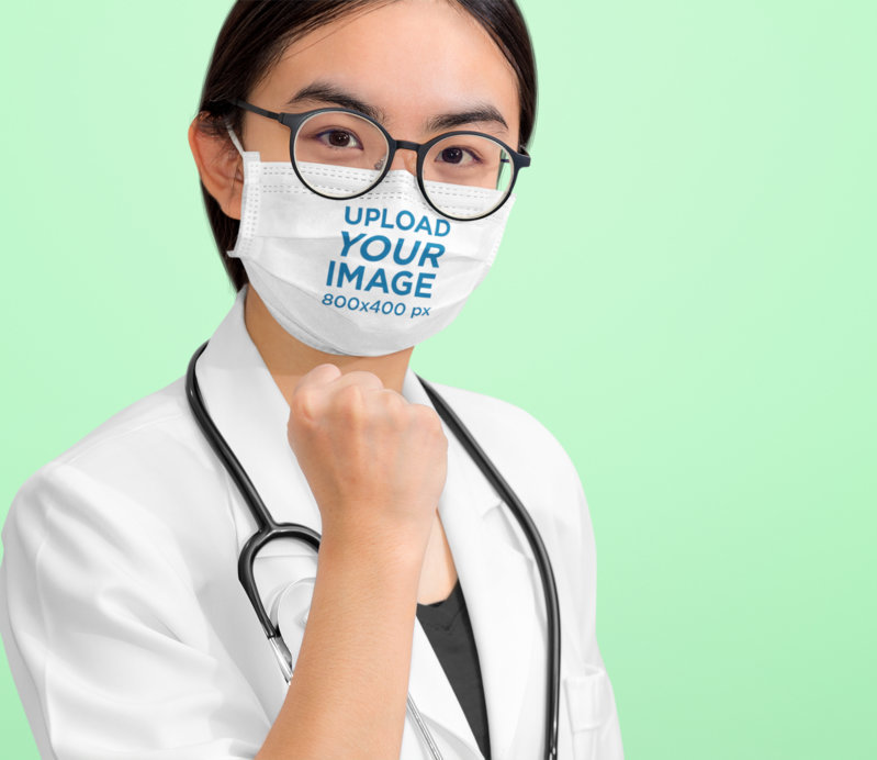 Placeit - Mockup of a Young Female Doctor Wearing a Face Mask at a Studio