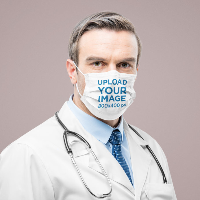 Placeit - Face Mask Mockup Featuring a Serious Doctor at a Studio