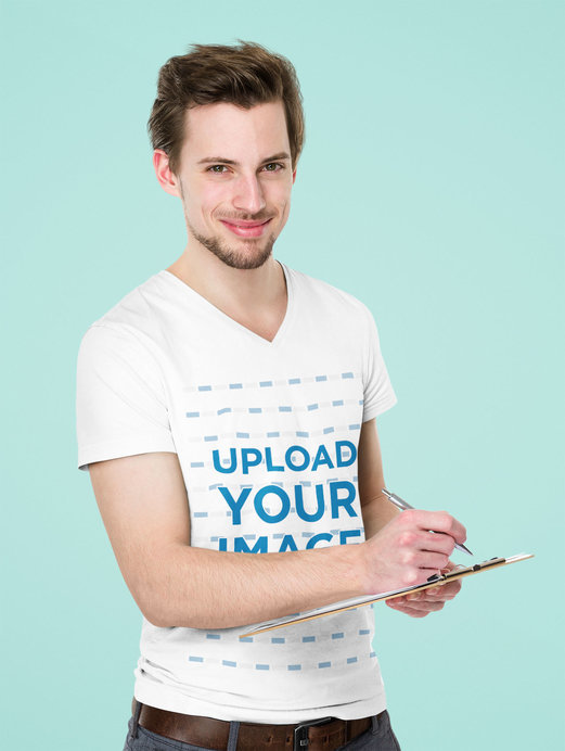 Placeit - V-Neck T-Shirt Mockup of a Man Taking Notes in a Studio