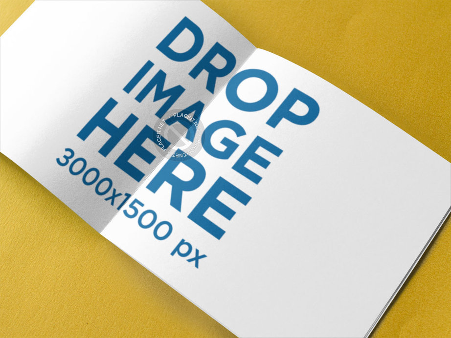 Placeit - Open Booklet on a Yellow Surface Mockup