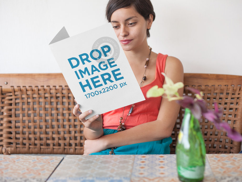 Placeit - Young Woman Reading a Restaurant Menu While Sitting Down Template