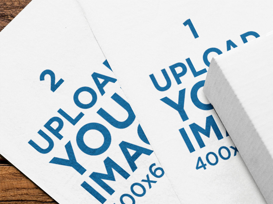 Placeit - Pair of Wrapping Papers Mockup Lying Together on a Wooden Surface