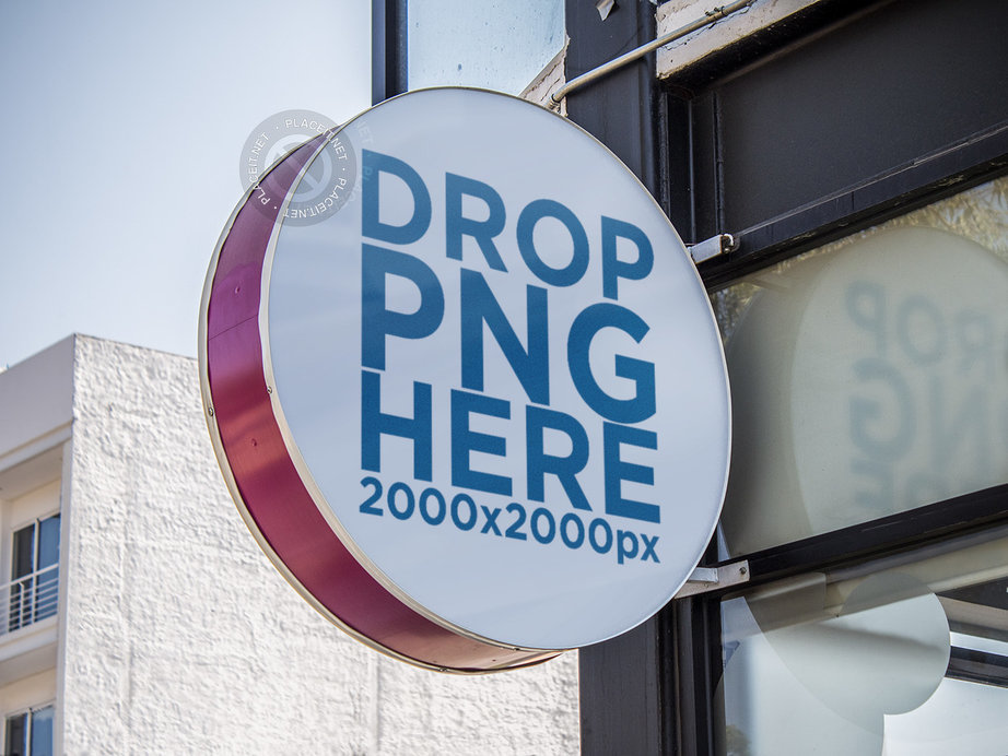 Placeit - Round Sign Mockup Hanging from Outside a Store