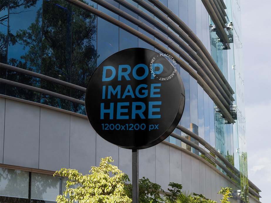 Placeit - Round Sign Mockup Standing Outside a Big Mall
