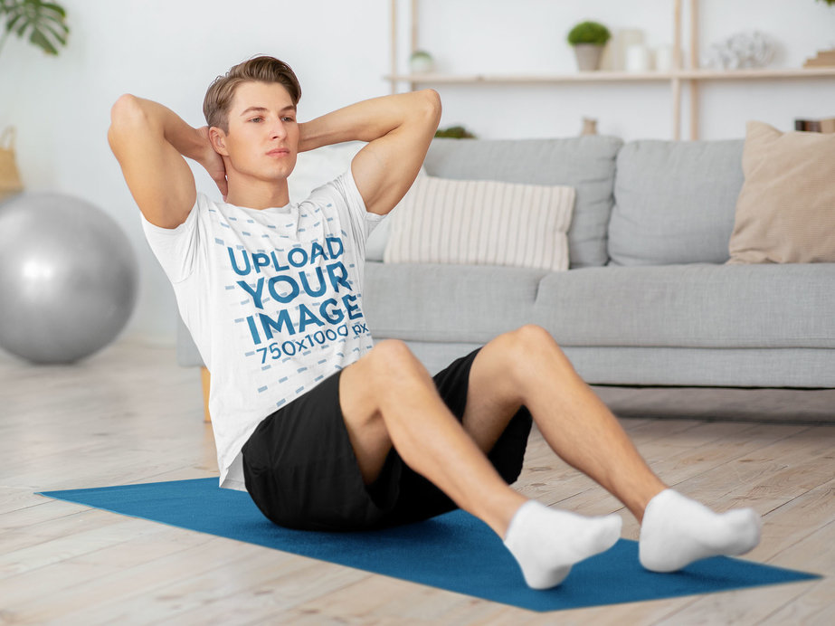 Placeit - T-Shirt Mockup Featuring a Man Doing Crunches at Home